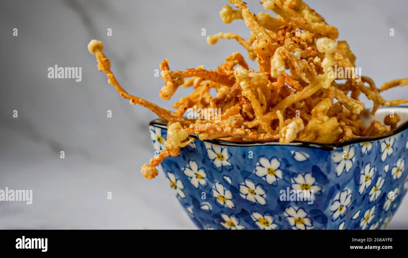Crunchy deep fried Enoki Mushrooms with chilli flakes. Delicious snacks ...