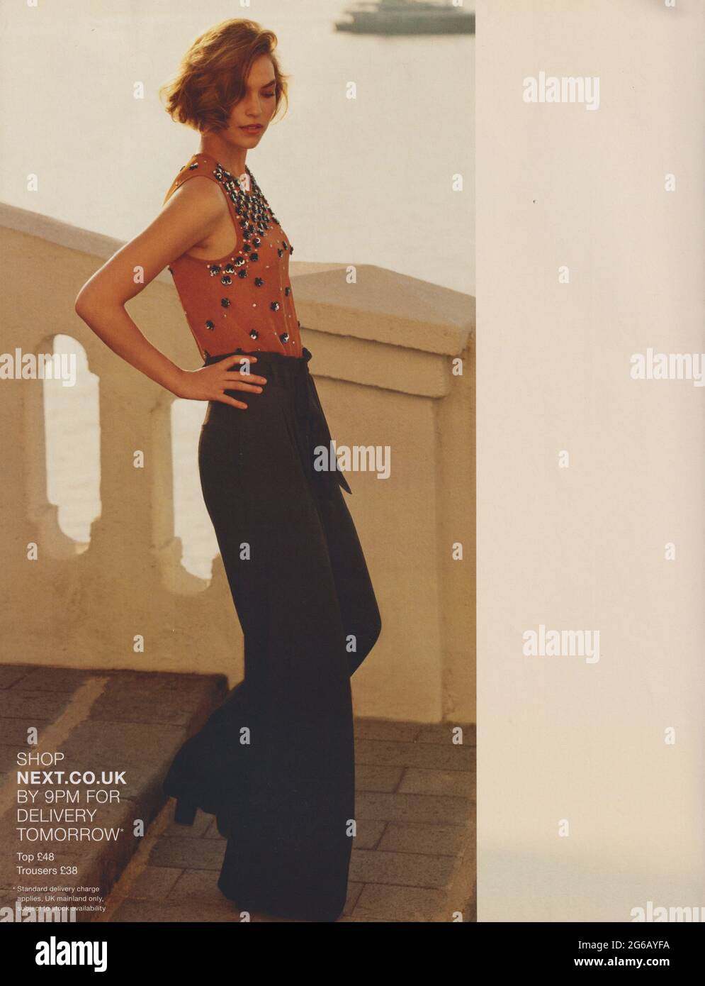 poster advertising Next fashion house with Arizona Muse in paper ...