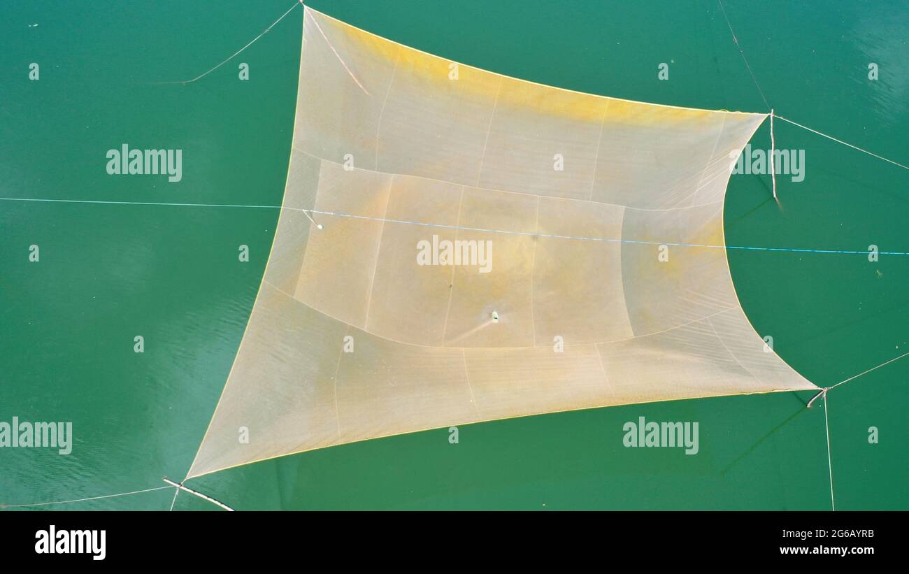Yellow fishing net on the river central Vietnam Stock Photo - Alamy