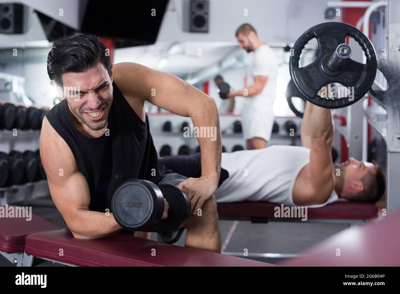 Guy during workout in gym with dumbbells Stock Photo - Alamy