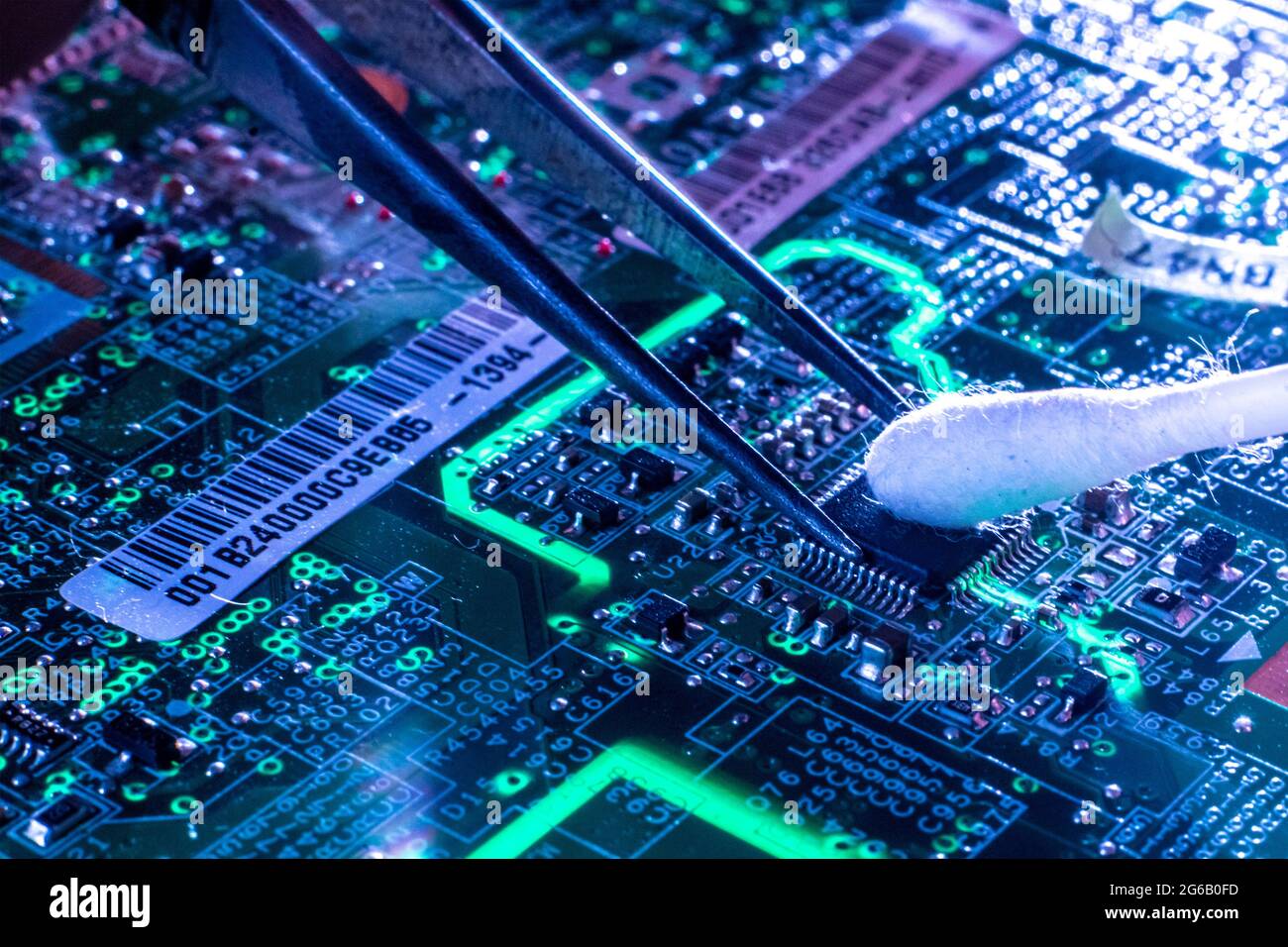 man cleaning dirty electric circuit with cotton stick macro shot of ...