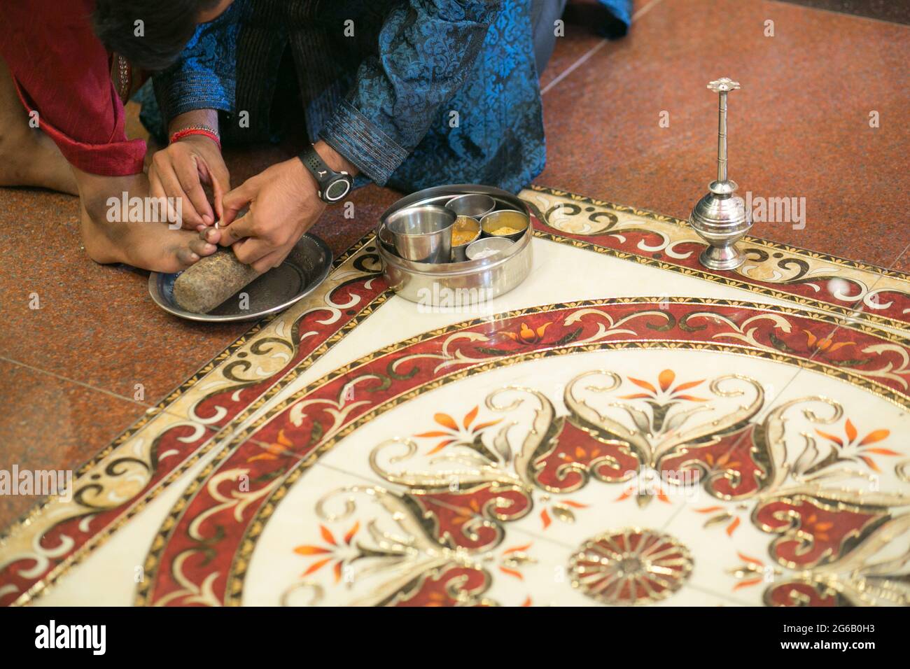 Indian traditional wedding ritual of putting a toe ring on a bride ...