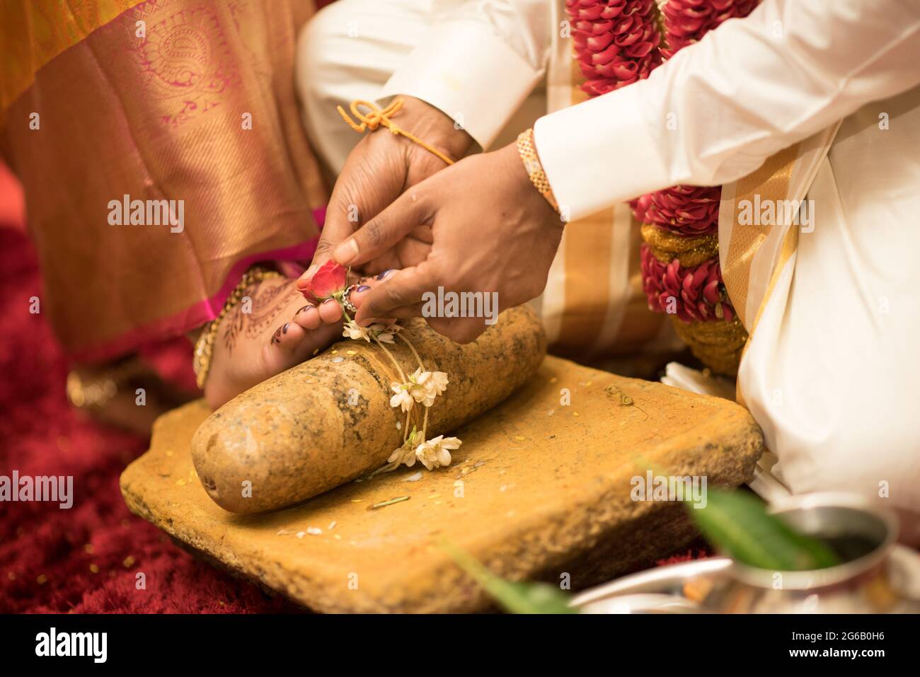 Traditional ritual of putting a ring on the bride's toe during a Hindu ...