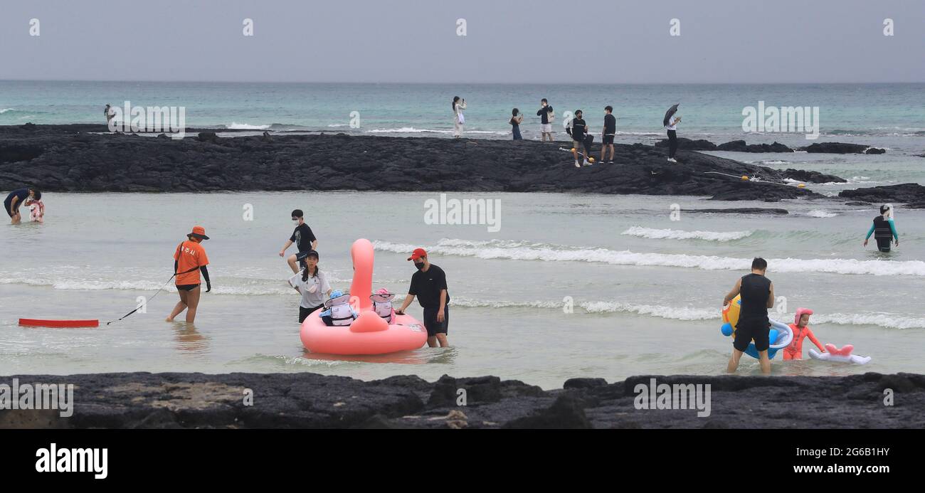 05th July, 2021. Enjoying beach on Jeju Island Swimmers play in the ...
