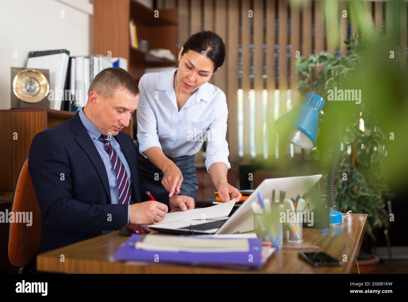 Asian female signing documents hi-res stock photography and images - Alamy