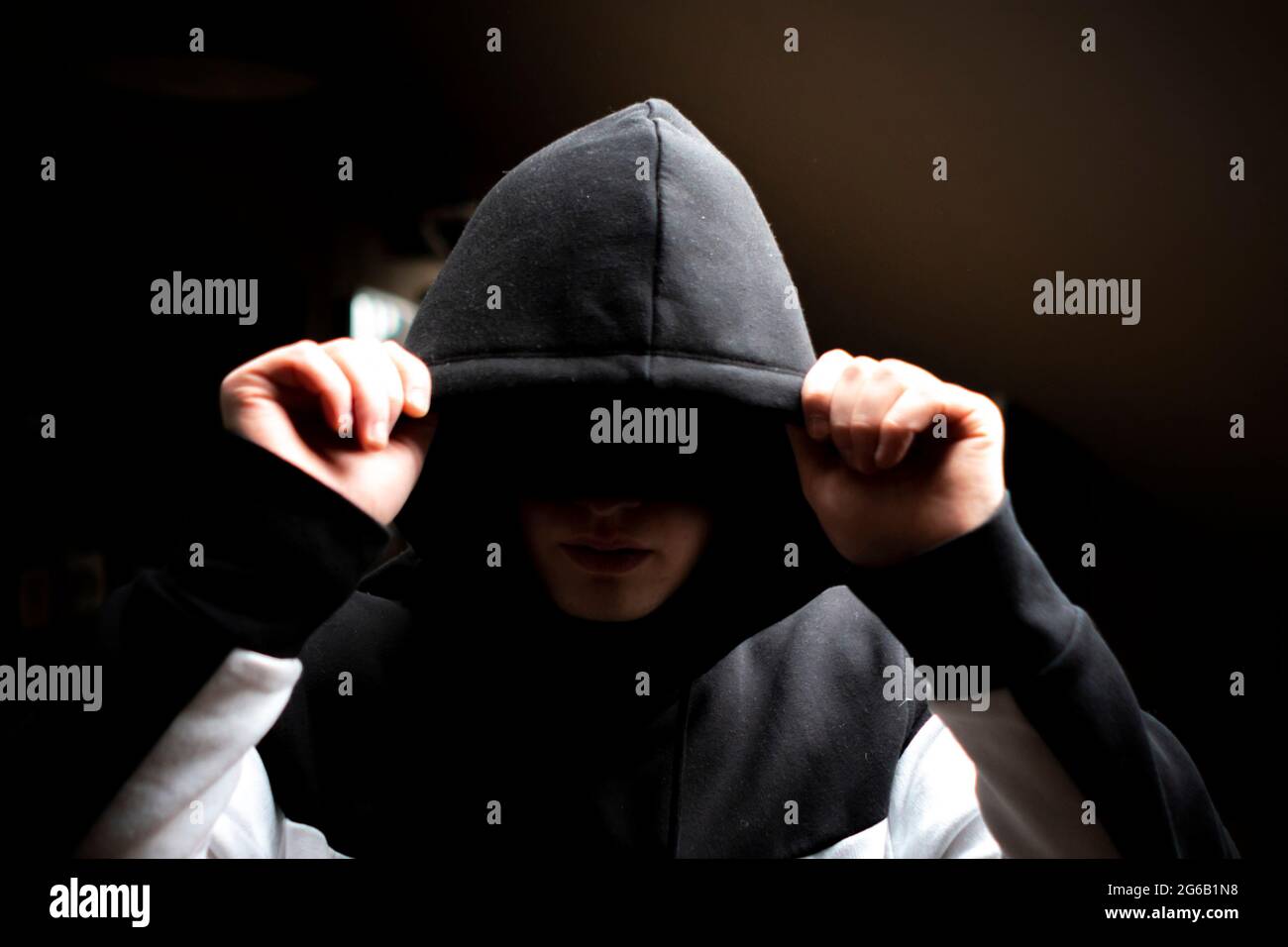 anonymous man in the dark hood standing in the mysterious pose Stock ...