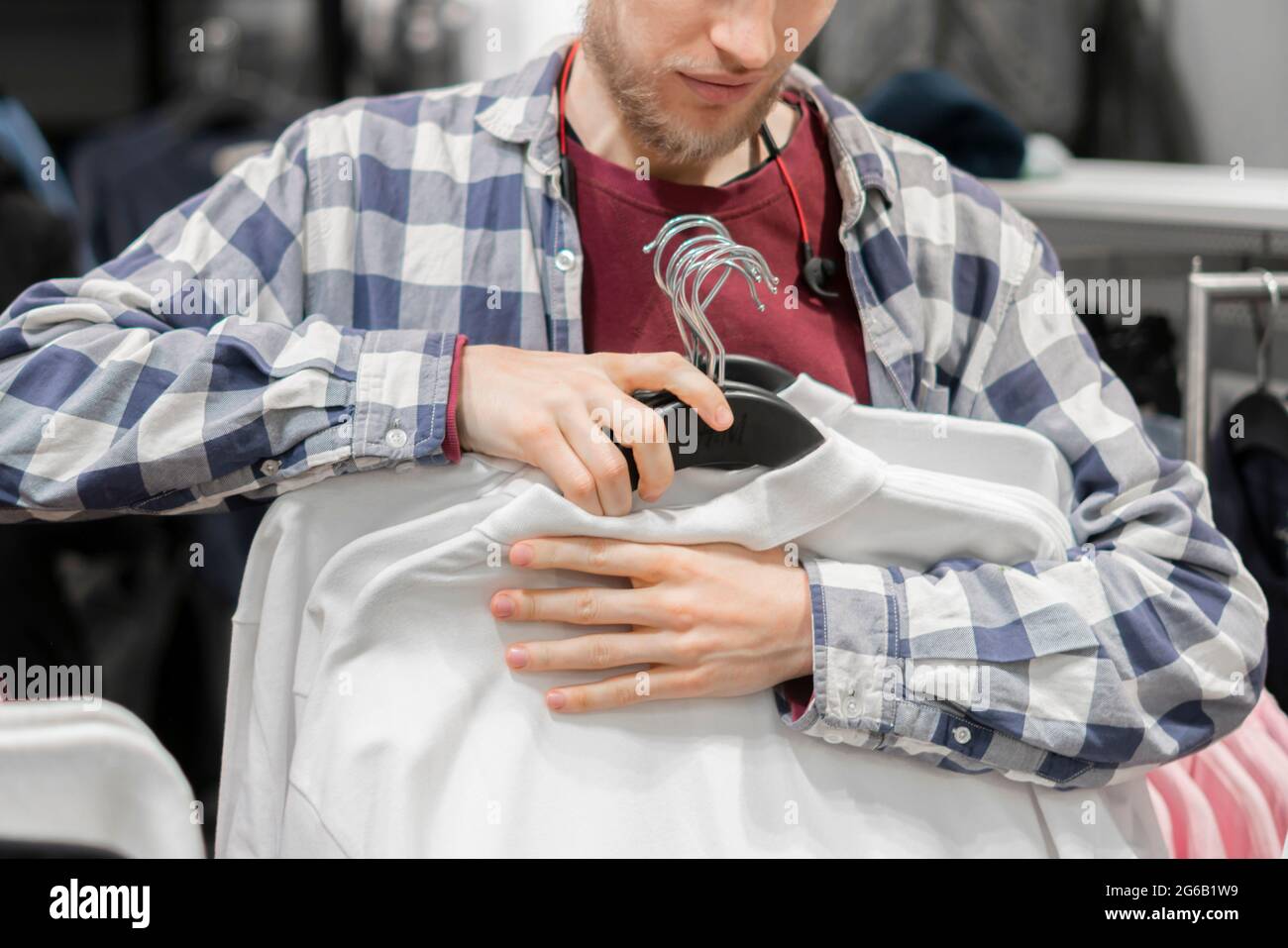 stressed person with bunch of brand new clothes in a boutique Stock ...