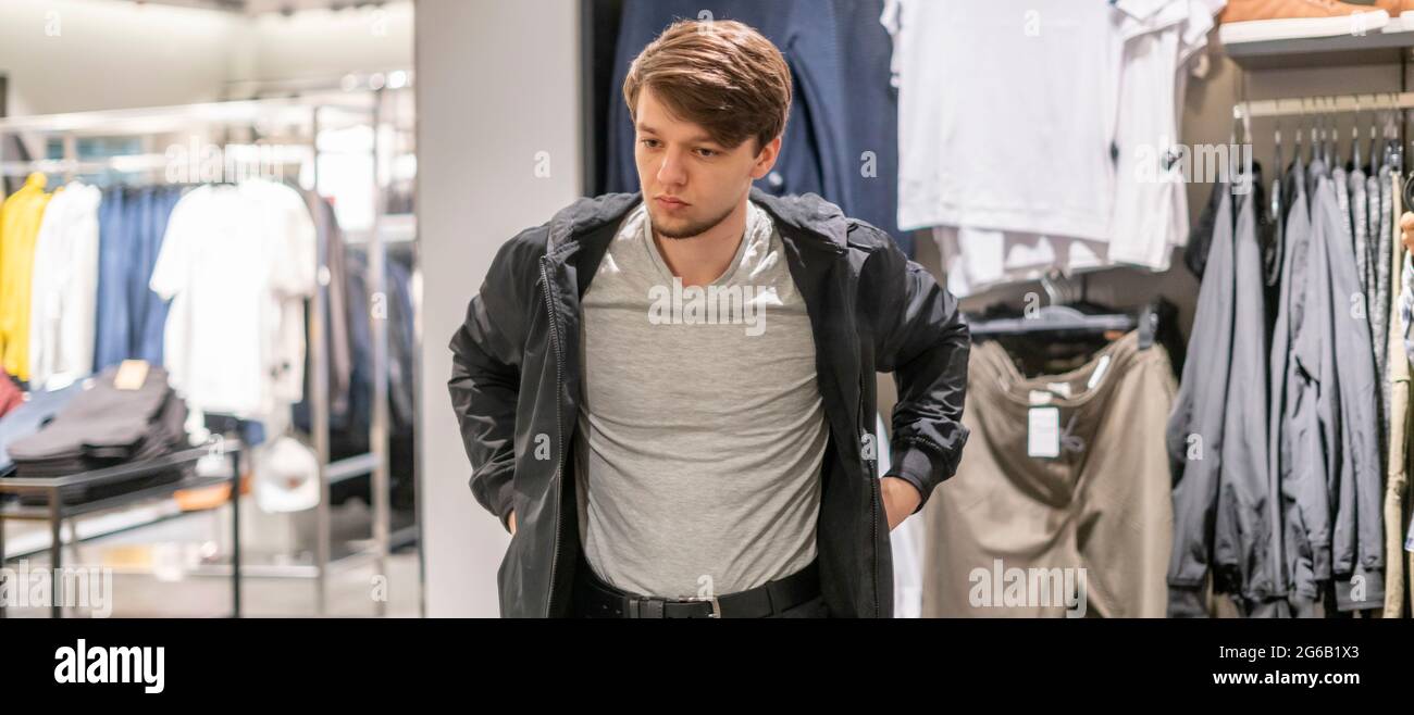 young businessman try on new jacket in the store Stock Photo - Alamy