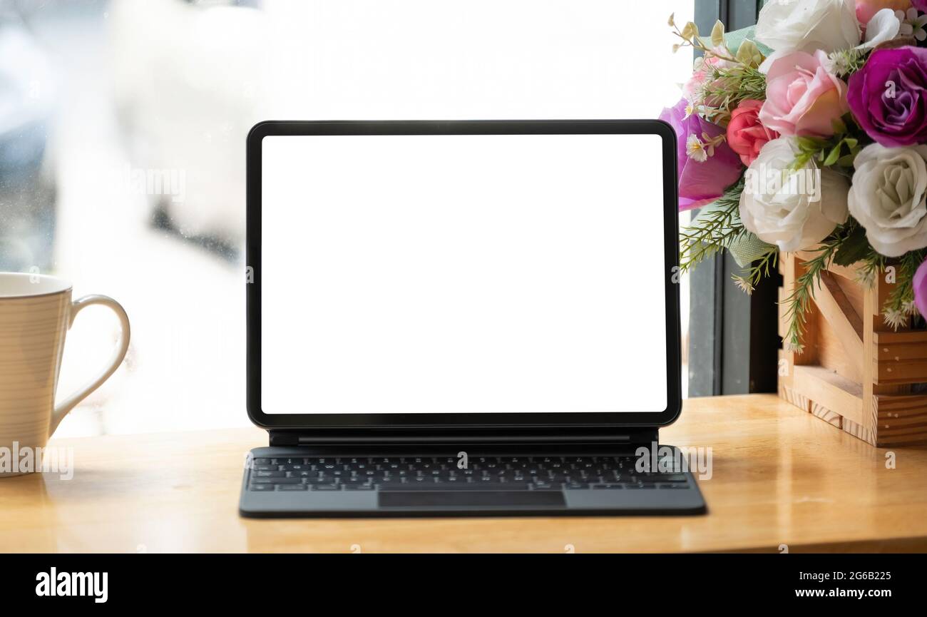 Digital tablet with keyboard with blank screen in coffee shop cafe ...