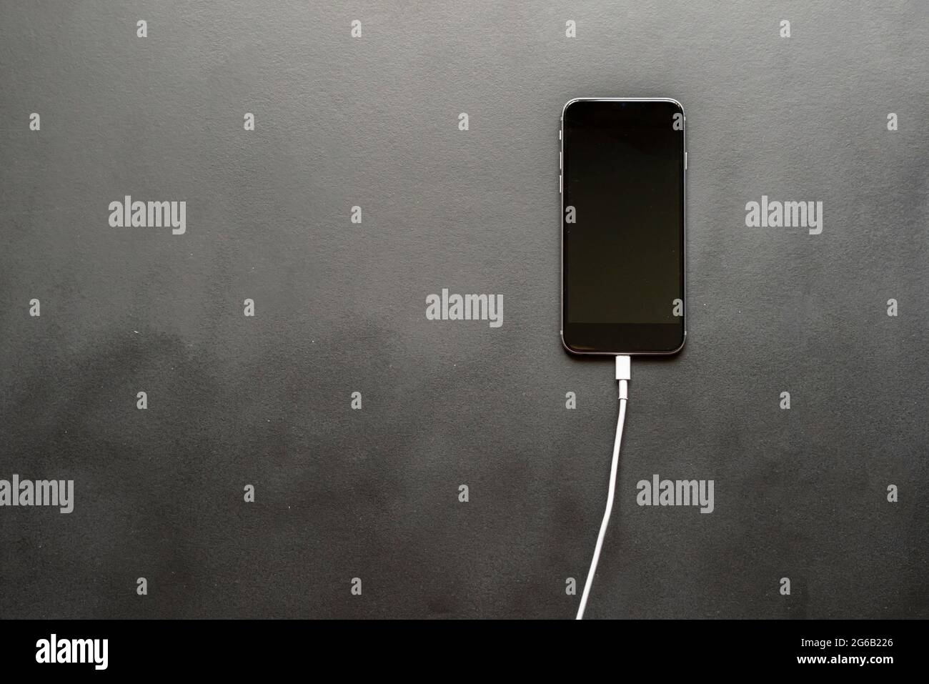 charging wire inserted in smartphone isolated Stock Photo - Alamy