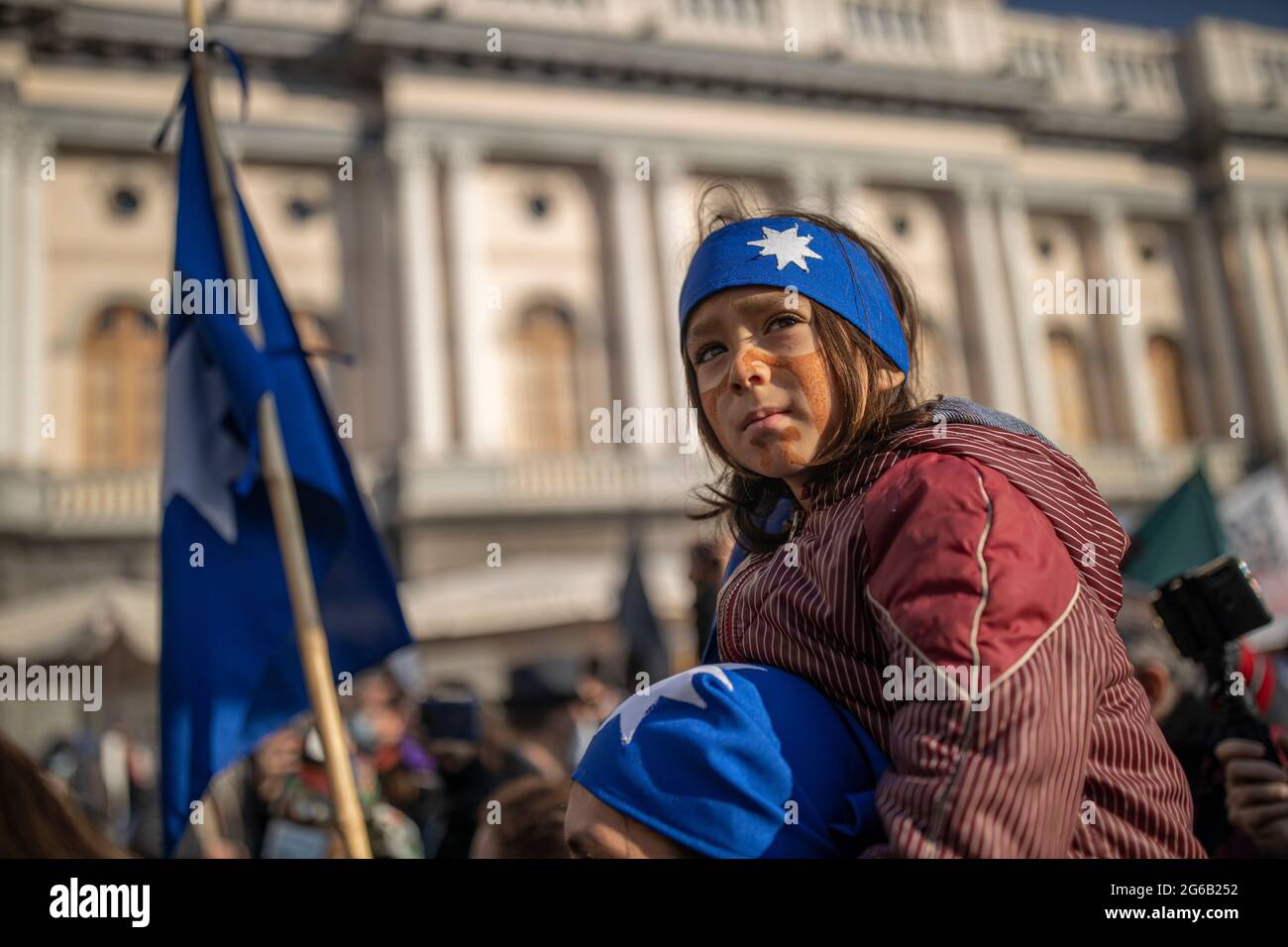 An indigenous child observes a Mapuche ritual during the demonstration ...