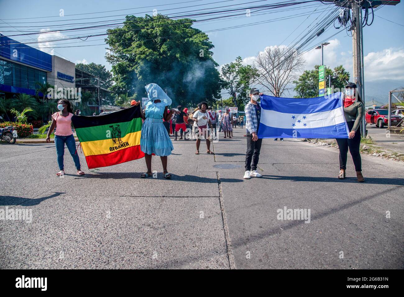 Protestors hold an OFRANEH (Black Fraternal Organization of Honduras ...