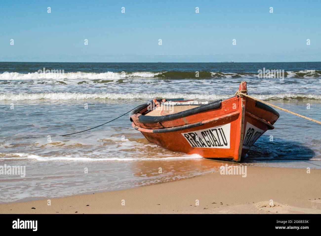 Orange fishig boat in the beach Stock Photo - Alamy