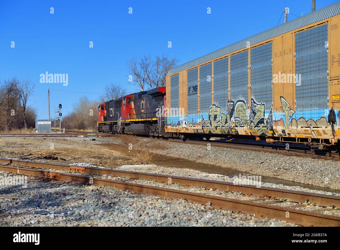 Bartlett, Illinois, USA. Two Canadian National Railway locomotives lead a freight train ...