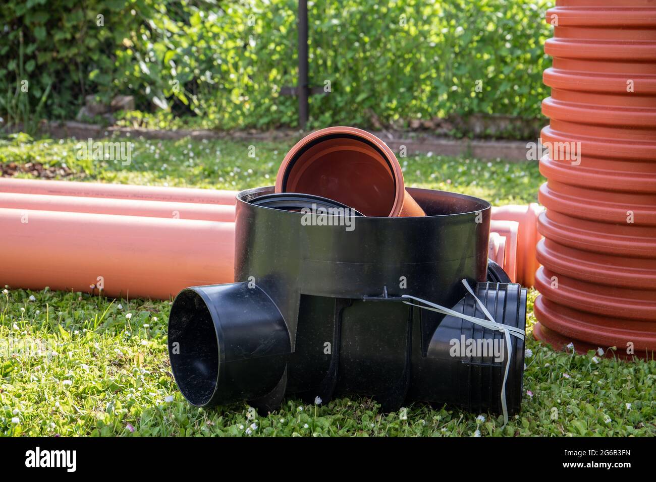 Orange plastic sewer pipes. Reconstruction and installation Stock Photo ...