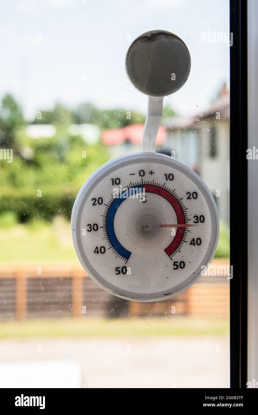 Extreme hot weather. round thermometer at a dirty window Stock Photo ...