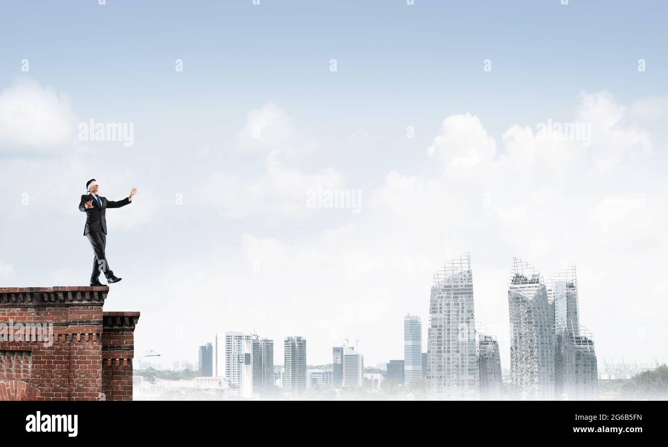 Danger and risk concept with businessman making step from edge Stock ...