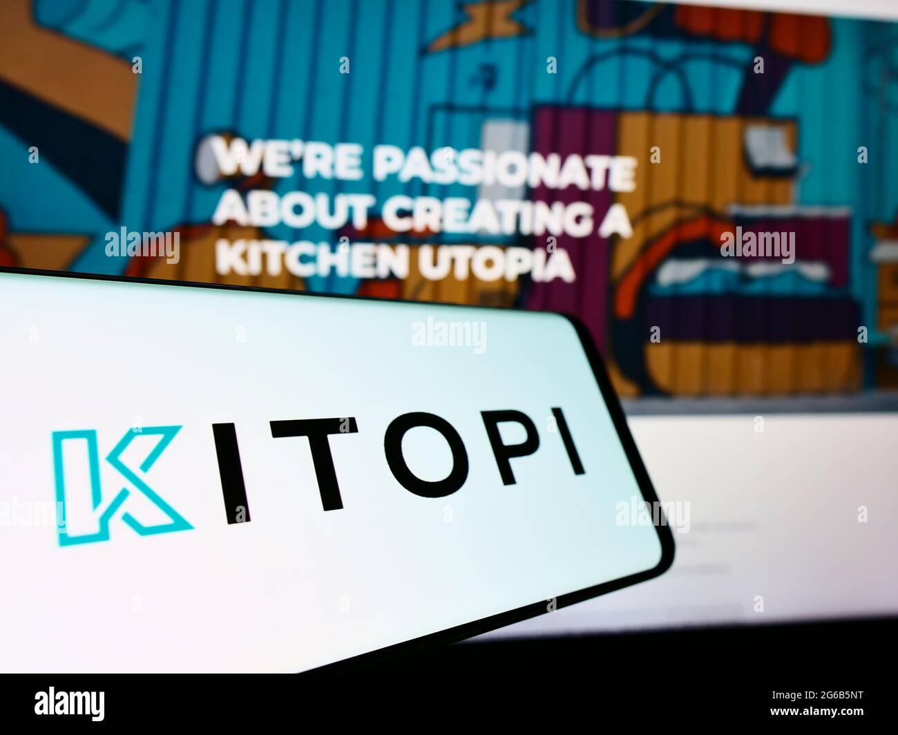 Cellphone with logo of cloud kitchen company Kitopi on screen in front ...