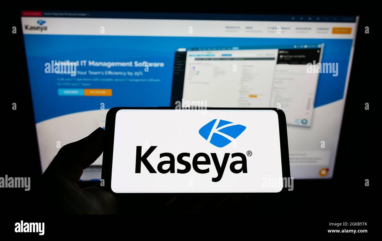 Person holding smartphone with logo of US IT security management ...