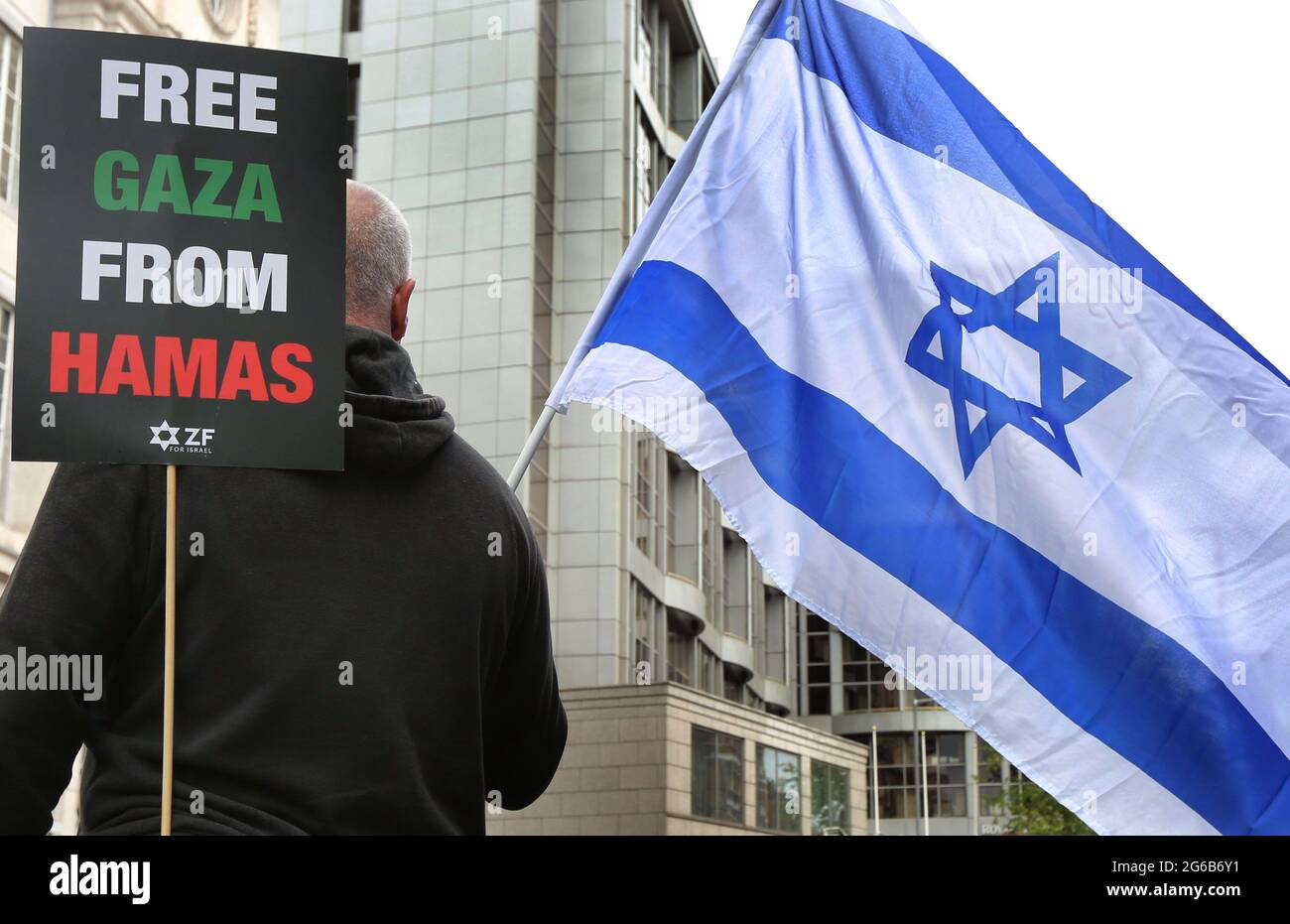 A protester holds a placard saying "Free Gaza from Hamas" and an ...