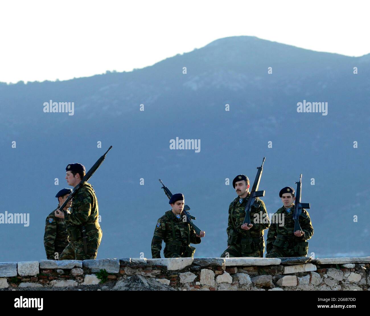 Greek solders saluting the Greek flag during the early morning flag ...