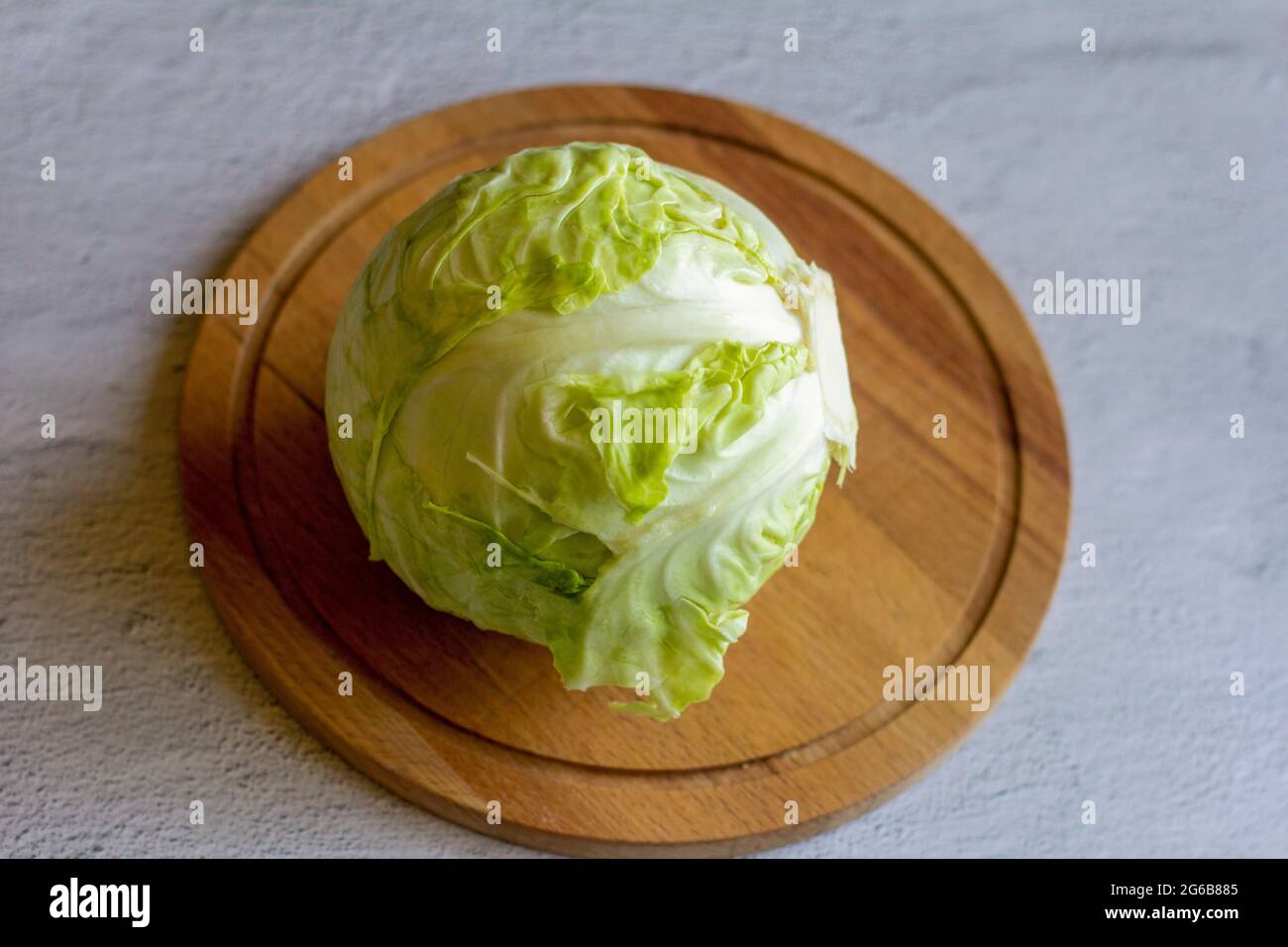 Early cabbage, white cabbage head on wooden background Stock Photo - Alamy