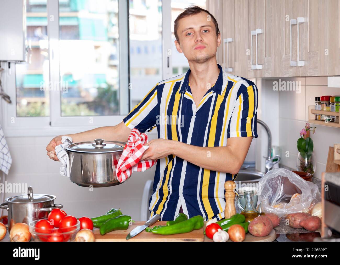 Ordinary man with a pot of soup in the kitchen Stock Photo - Alamy