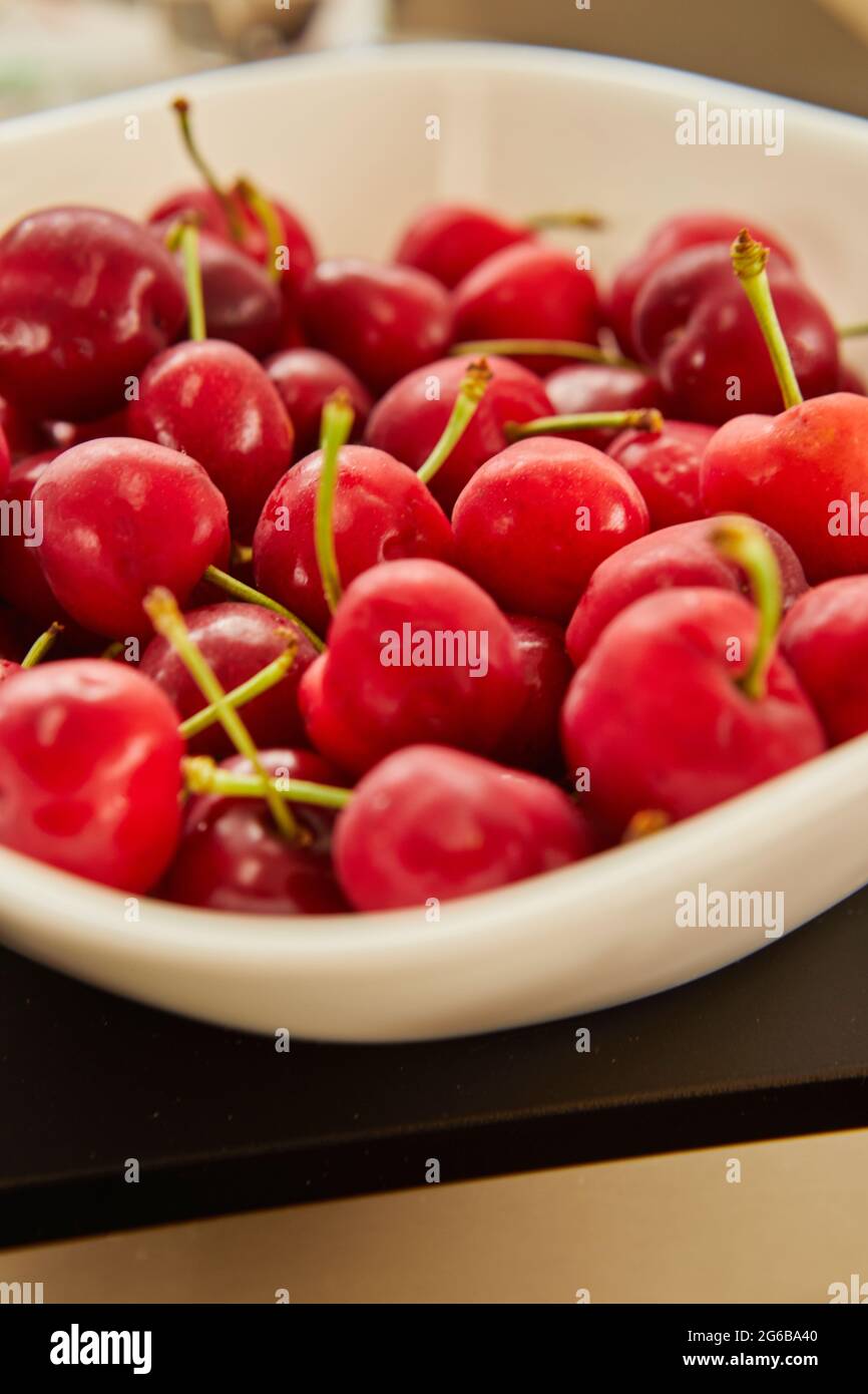 Fresh cherries in white plate, ready to eat Stock Photo - Alamy