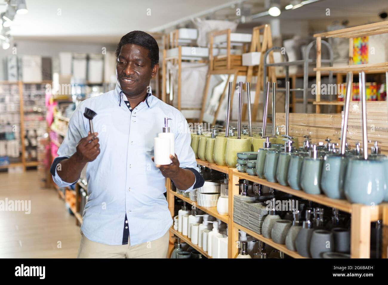 Male shopper chooses toilet brush at hardware store Stock Photo - Alamy