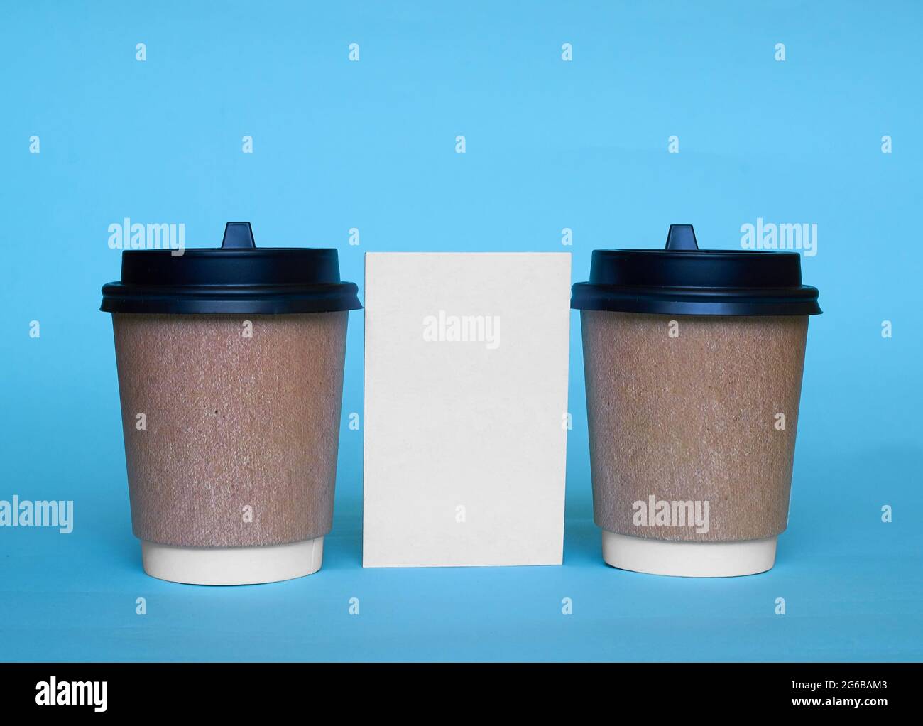Two paper cups for coffee and a white cardboard card. Copy space Stock ...