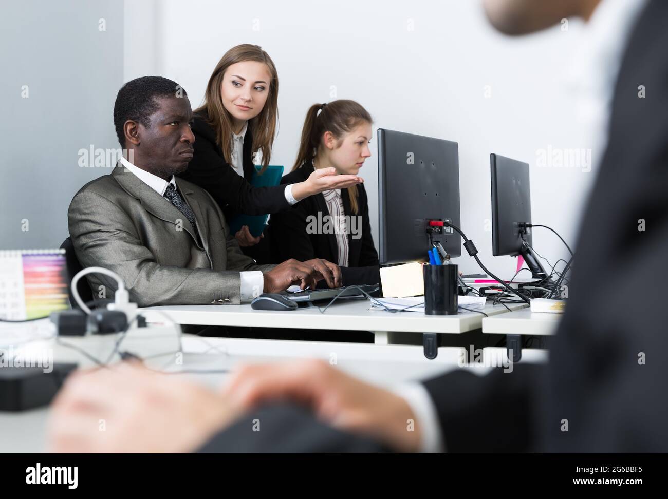 Young manager helping colleague hi-res stock photography and images - Alamy