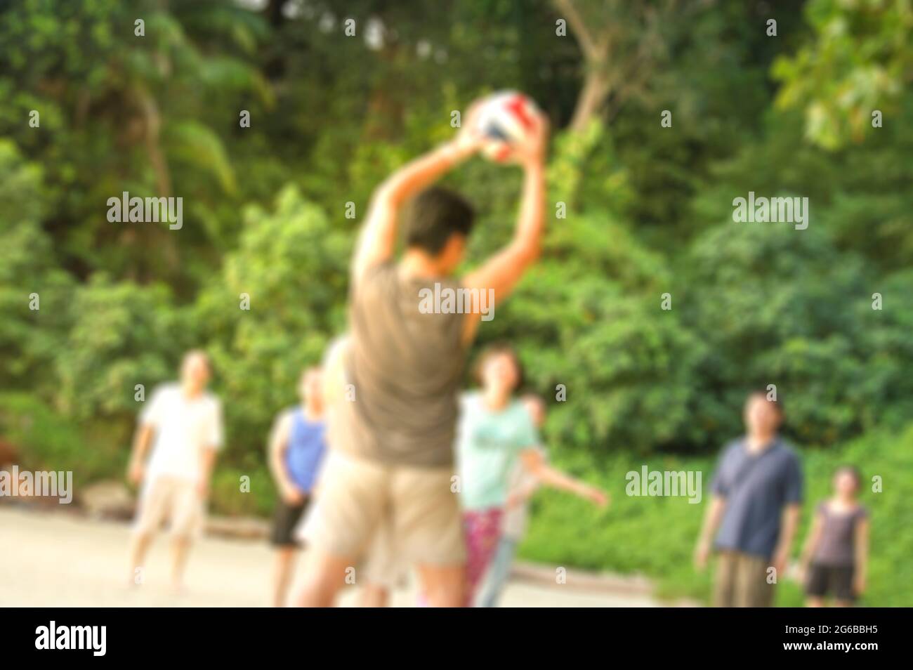 People playing ball game outdoors, defocused. Blur image as summer ...