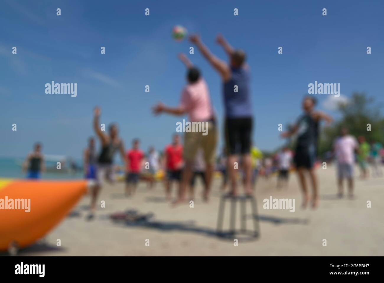 Group of people playing ball game on the beach. Defocused. Summer ...