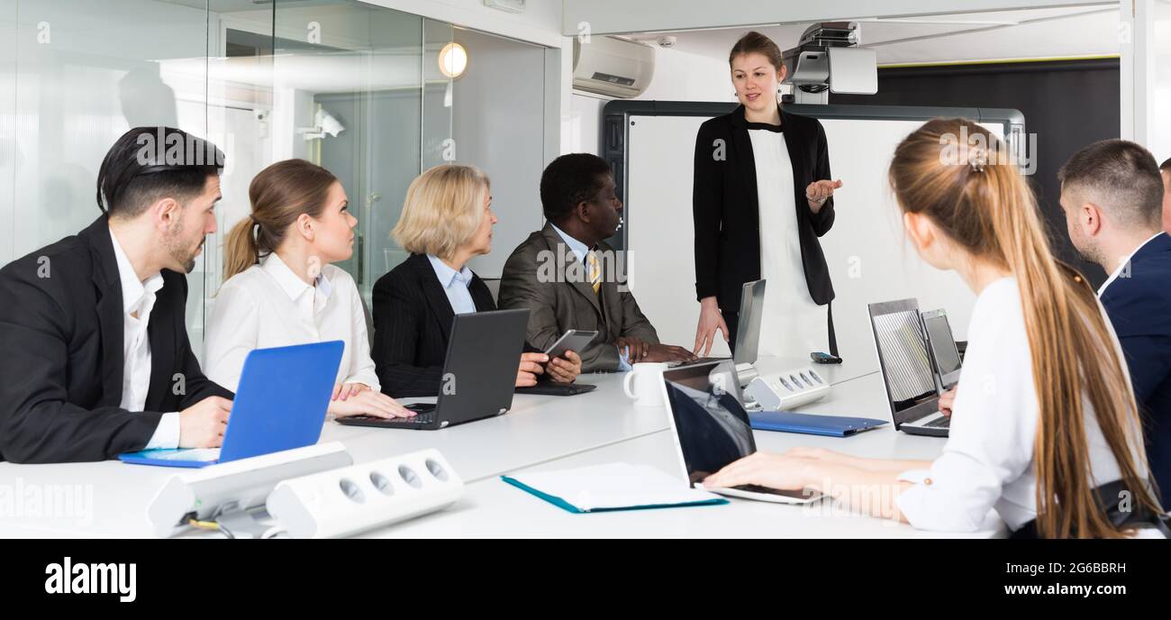 girl making presentation to colleagues Stock Photo - Alamy