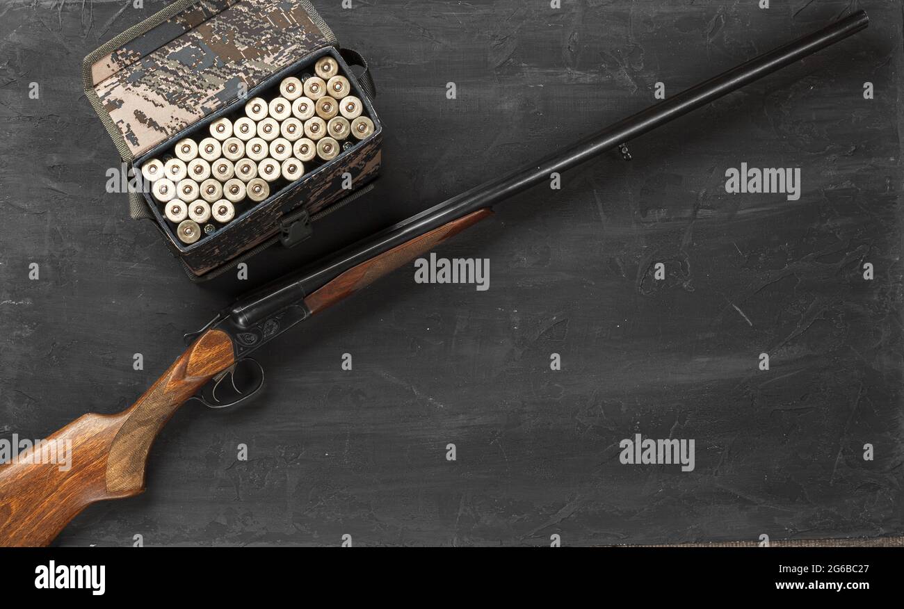 Hunting weapon on dark wooden backgorund, top view Stock Photo - Alamy