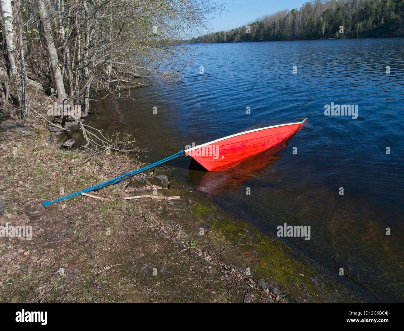 Sunken rowing boat on the shore Stock Photo - Alamy