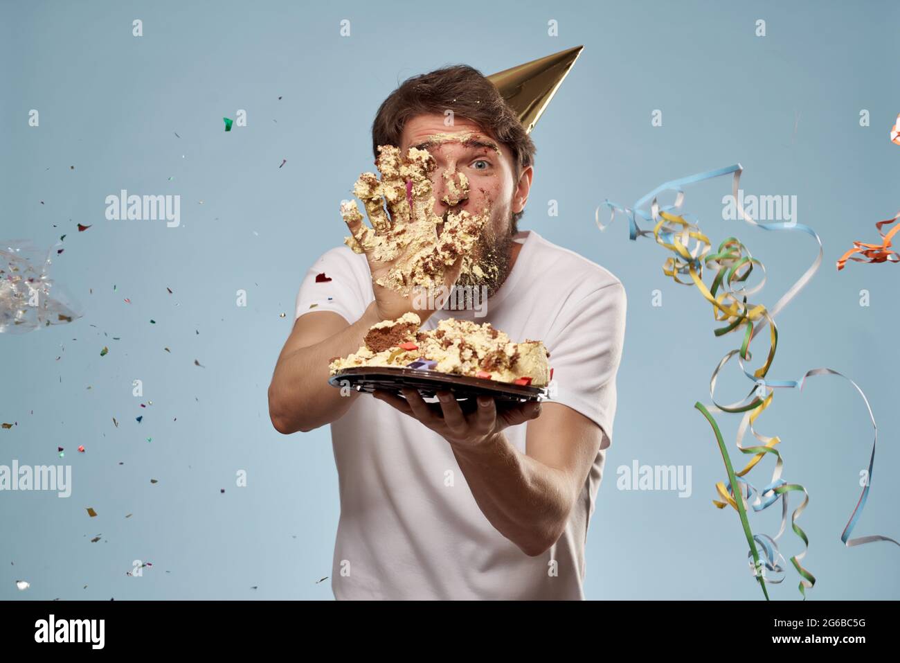 man holding cake smeared face birthday celebration fun Stock Photo - Alamy