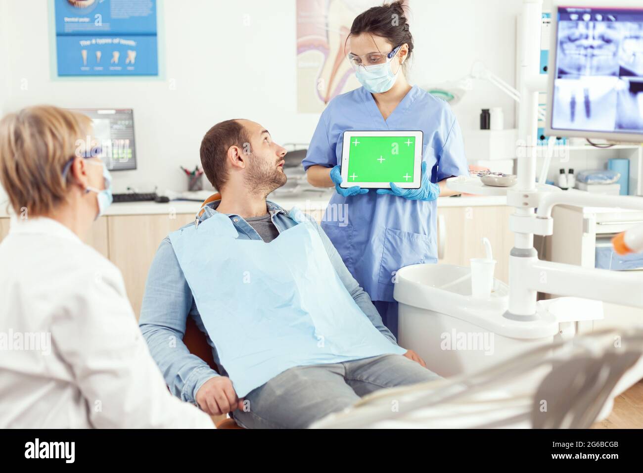 Sick man looking at mock up green screen chroma key tablet with ...