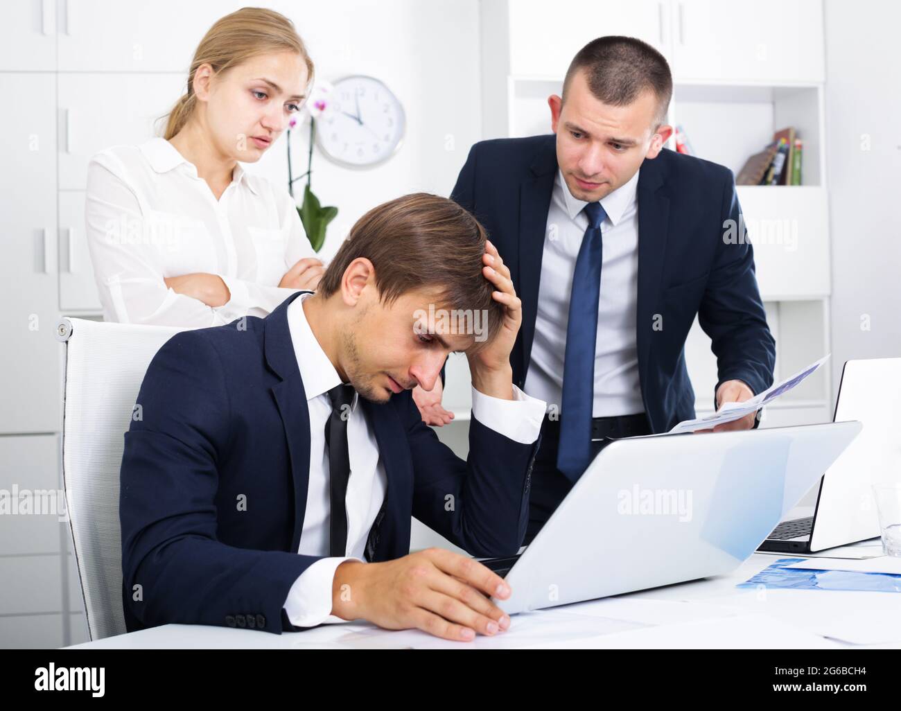 three concerned colleagues in office Stock Photo - Alamy