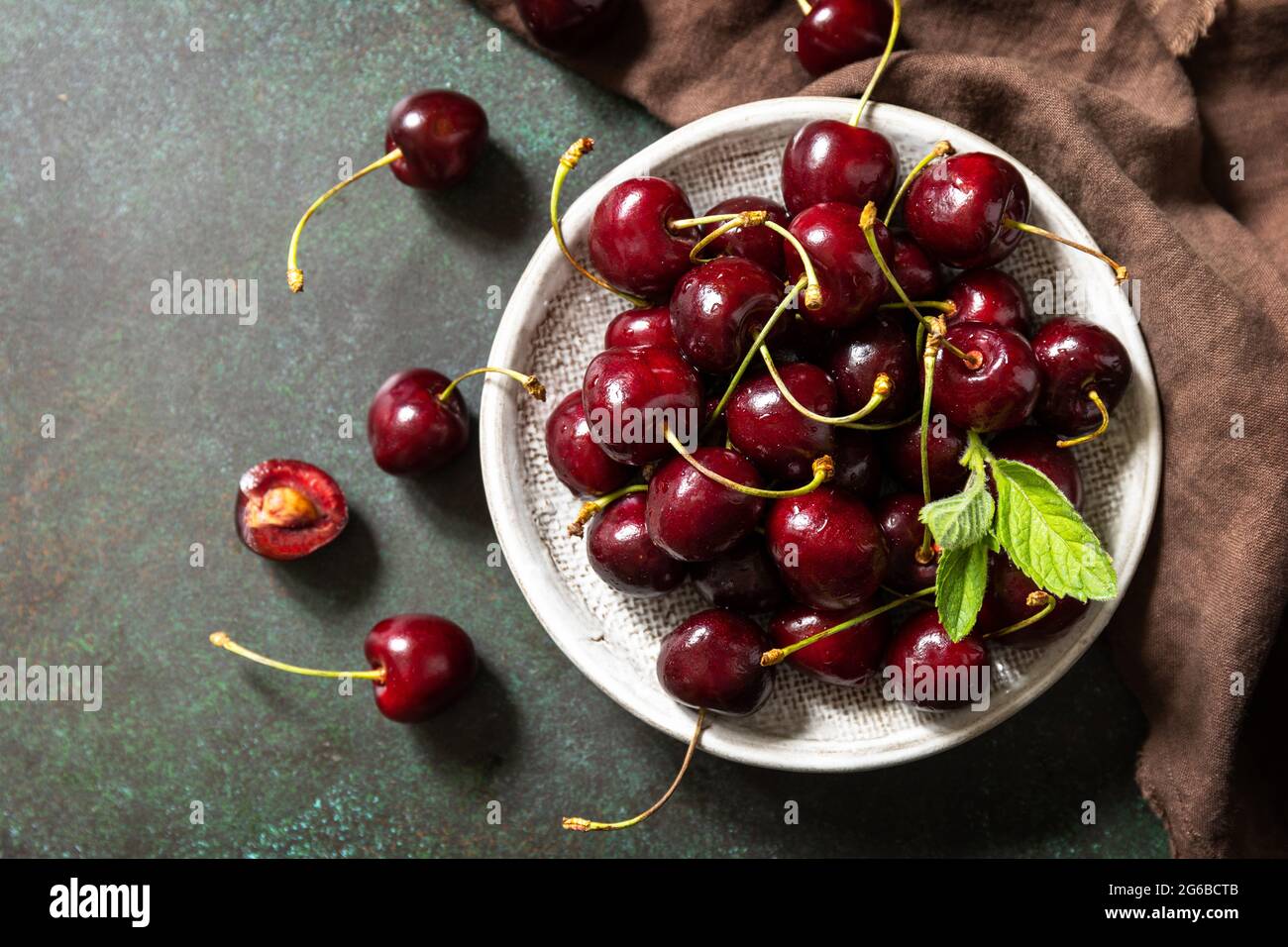 Ripe organic berry. Fresh Red sweet cherry on plate on a dark stone ...