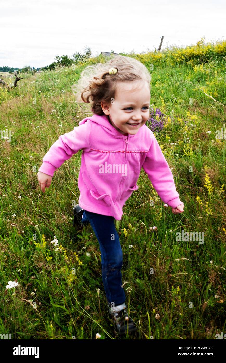 Girl child running through field hi-res stock photography and images ...