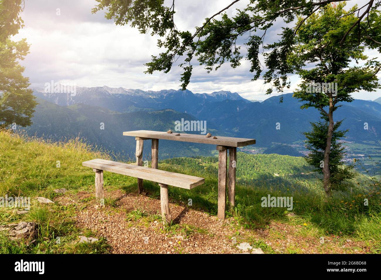 Bench and table in the mountains with view on Alps and alpine valley ...