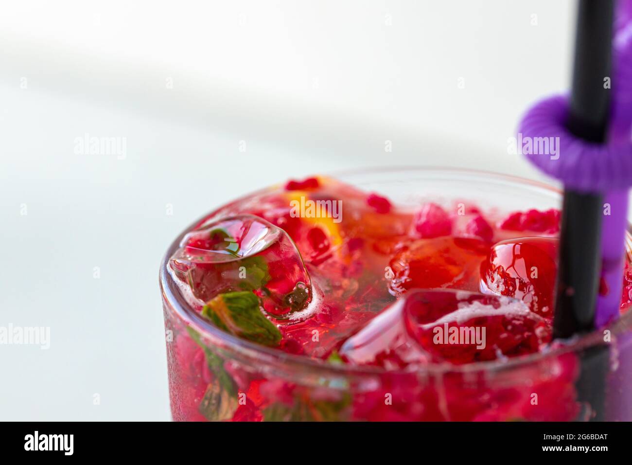Berry lemonade with ice on white background Stock Photo - Alamy