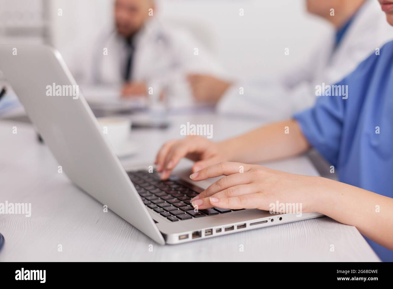 Close-up of practitioner woman nurse hand typing sickness treatment on ...