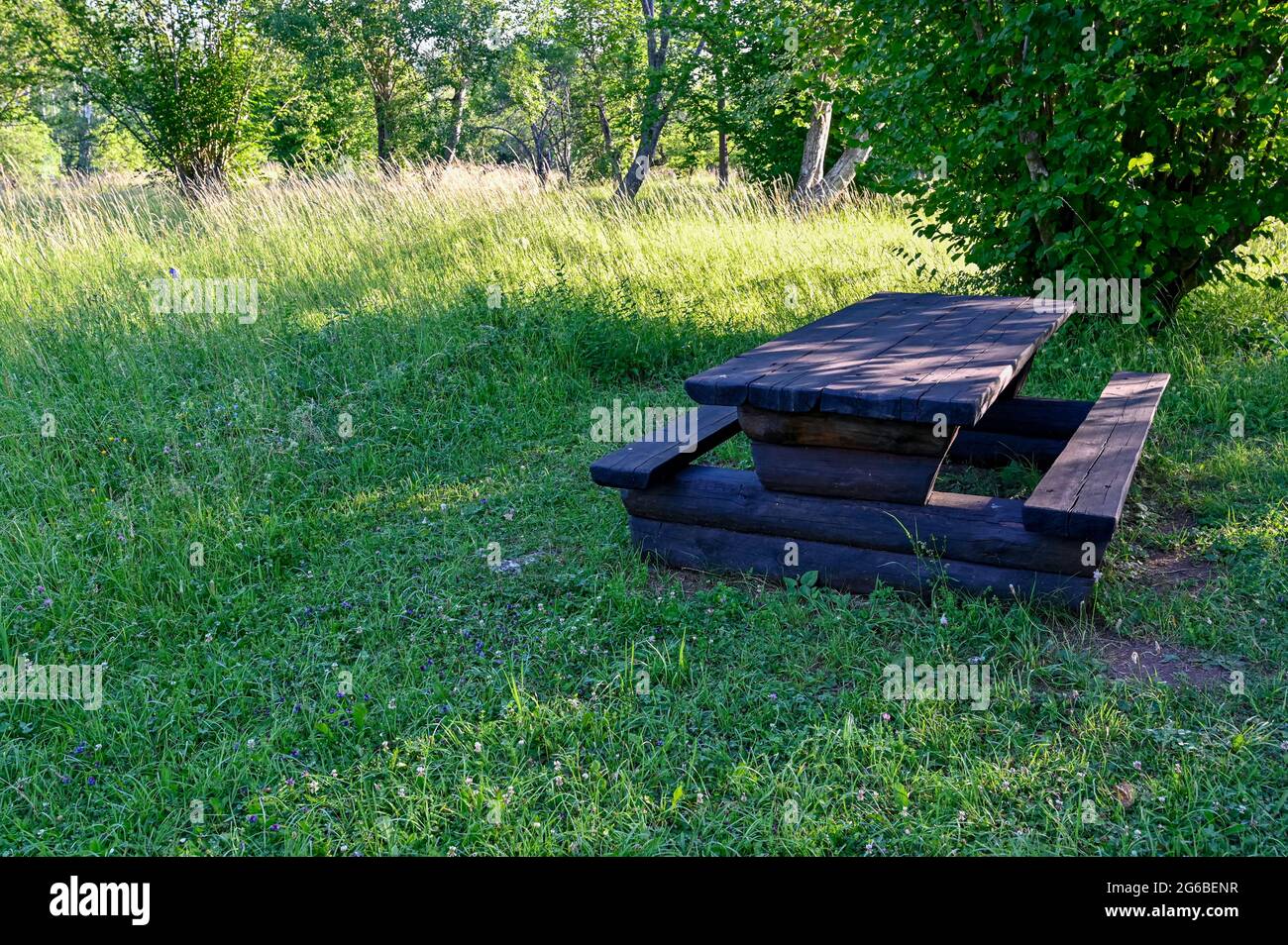 wooden table and benches at resting area Stock Photo - Alamy