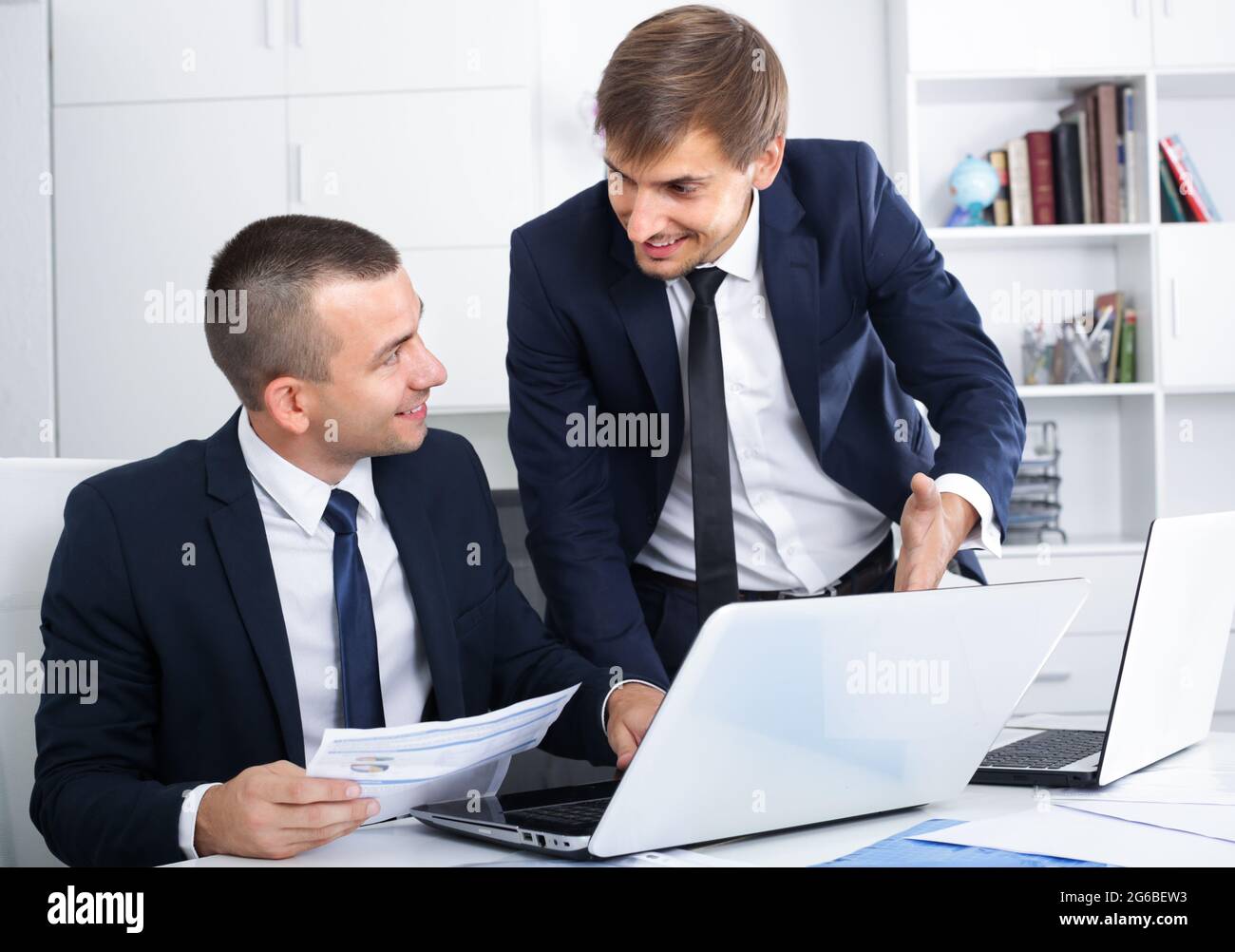 Positive young caucasian coworkers sitting hi-res stock photography and ...