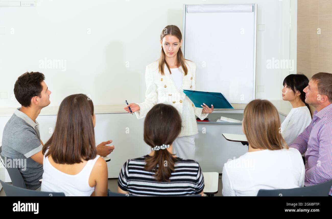 Woman sharing business ideas with colleagues Stock Photo - Alamy