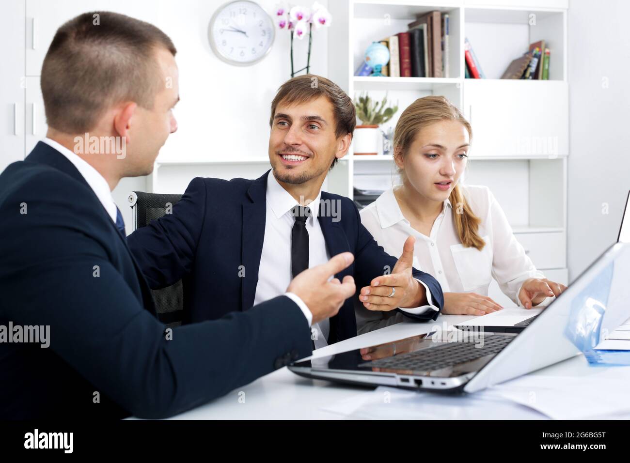 Business colleagues chatting about work task Stock Photo - Alamy