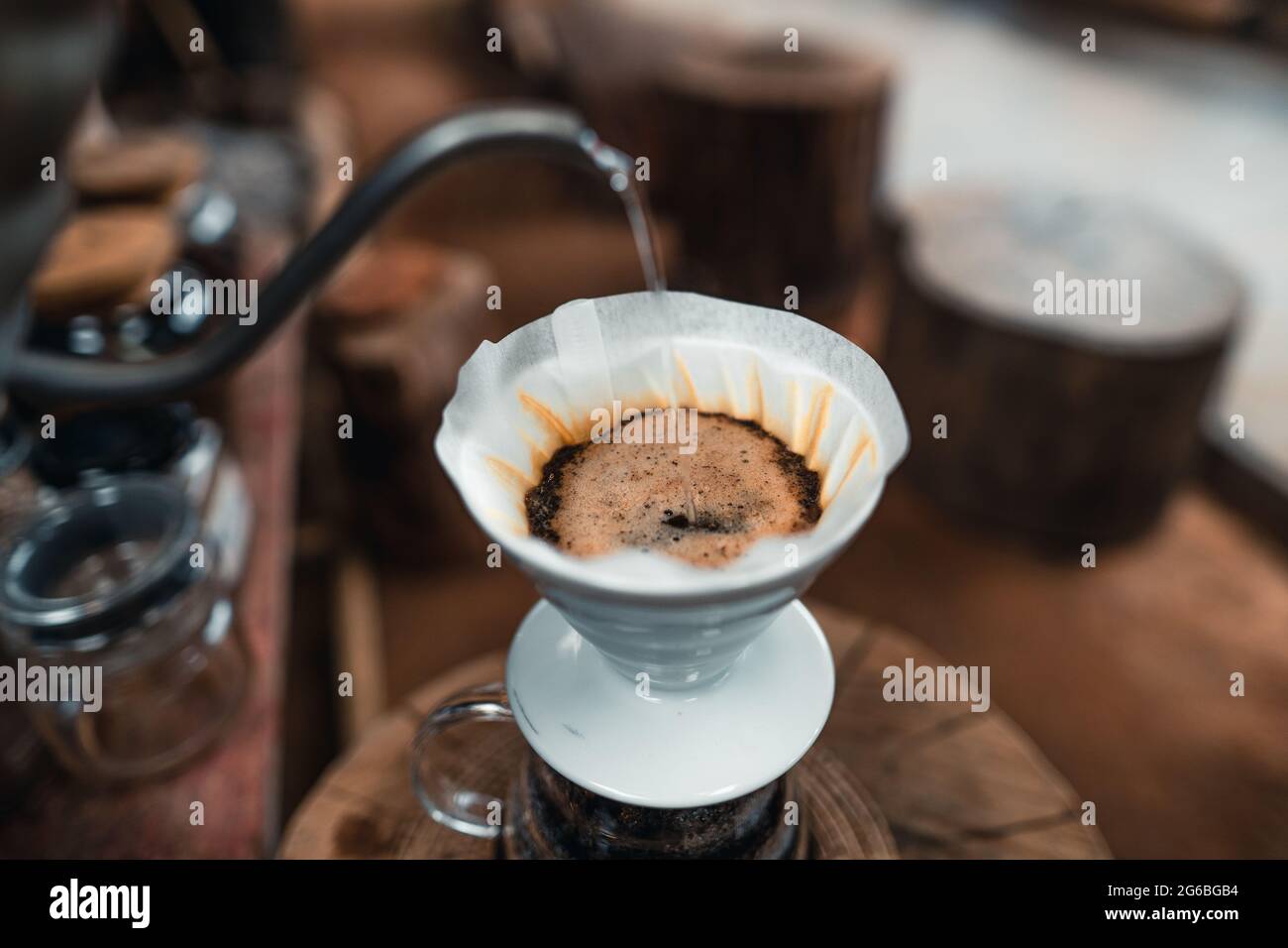 Man adding hot water into coffee dripper above glass jar Stock Photo ...