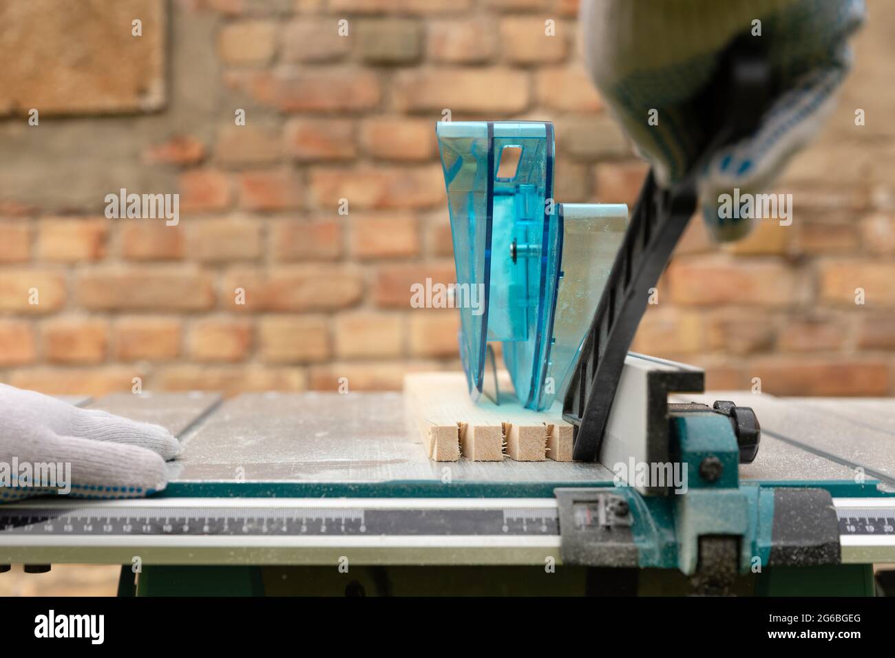 Handy man cutting wood on a table saw. Carpentry wood work Stock Photo ...